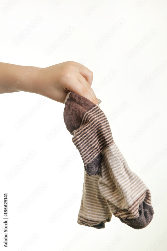 Studio shot of young boy holding stinky sock Stock-Foto | Adobe Stock