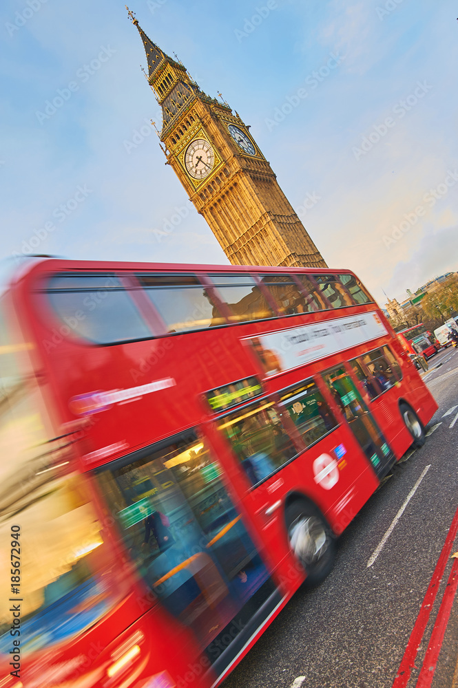 Big Ben daytime and red double decker bus blurred with his movement ...