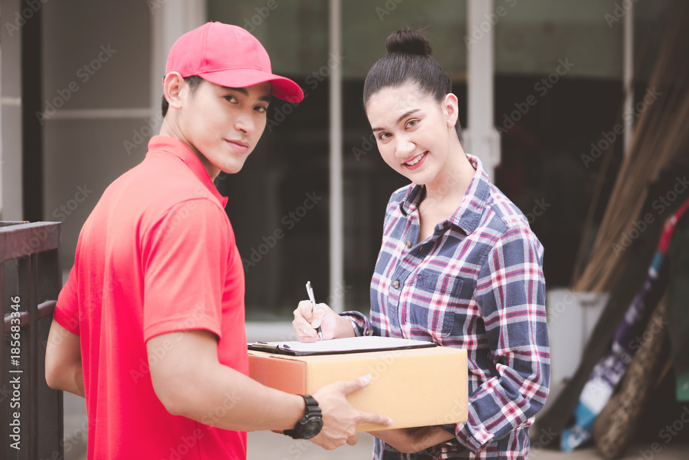 Young logistic career concept. Happy delivery man giving his package to ...