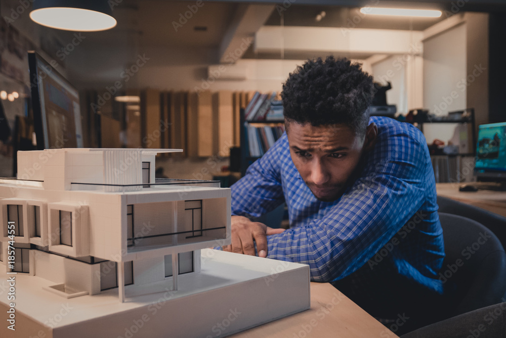 Young confident African American black male architect working on a ...