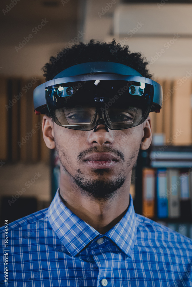 Portrait of young African American black male professional using ...