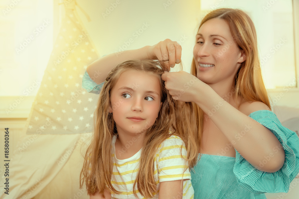 hair dressing mother with daughter preparing for school day Stock Photo ...