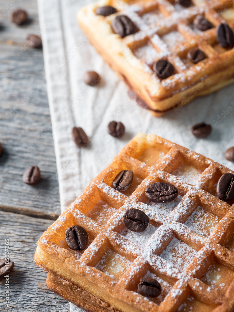 Soft Viennese Belgian waffles with powdered sugar and coffee beans on ...