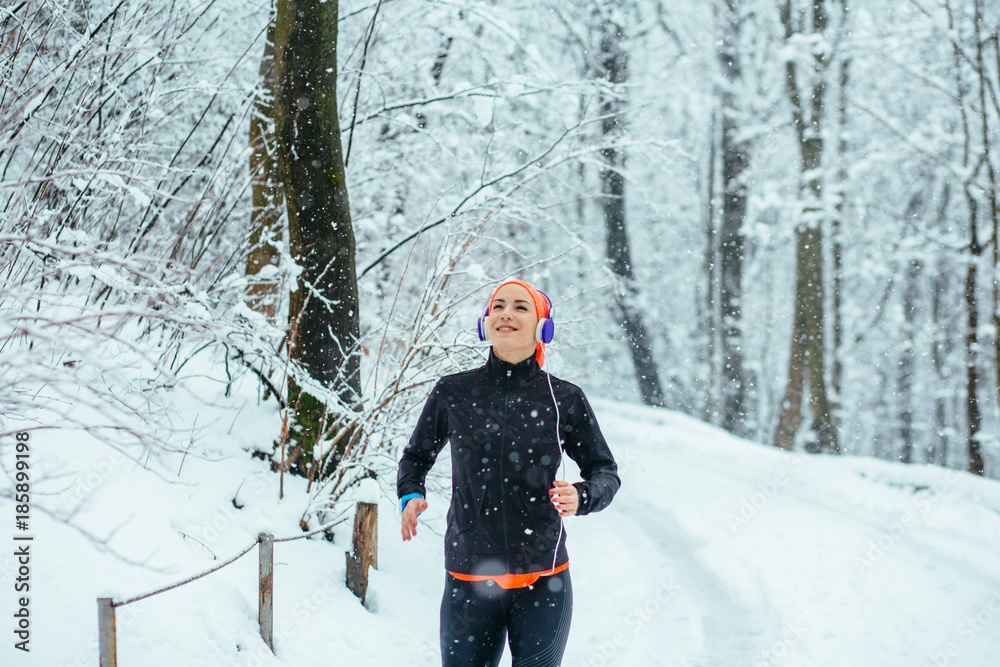 Running sport woman enjoying winter. Female runner jogging in cold ...