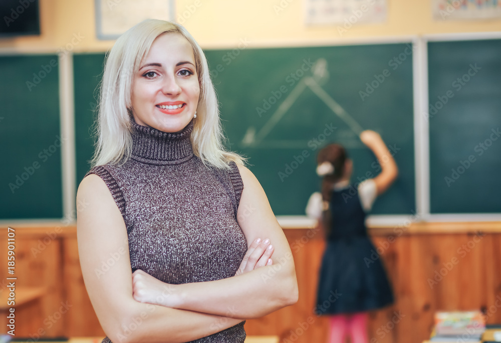 Cute female teacher on classroom background and students Stock Photo ...