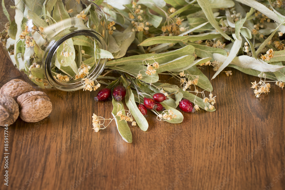 Healthy concept view of dry linden flowers, red rose hips and nuts on ...