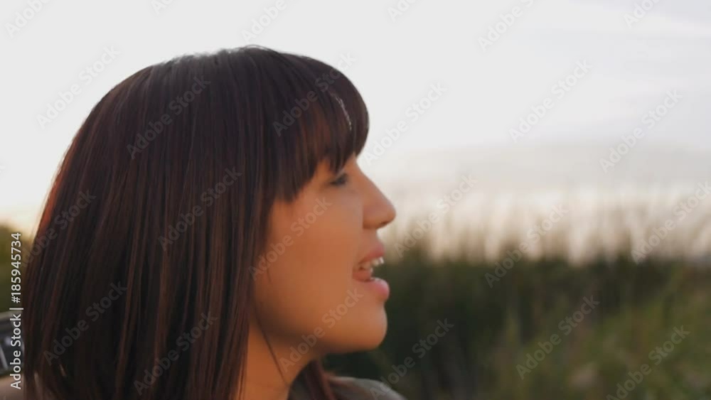 Woman and man sing a song with a guitar. Closeup of hispanic woman ...