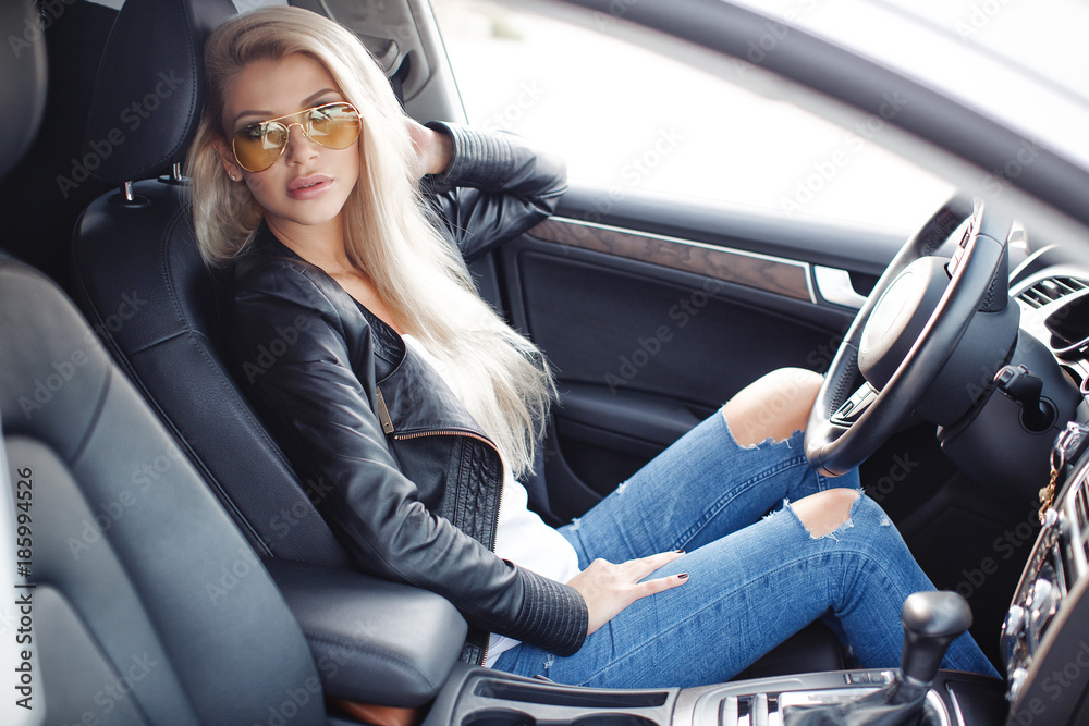 Young woman driving a car in the city.Successful, attractive, beautiful ...