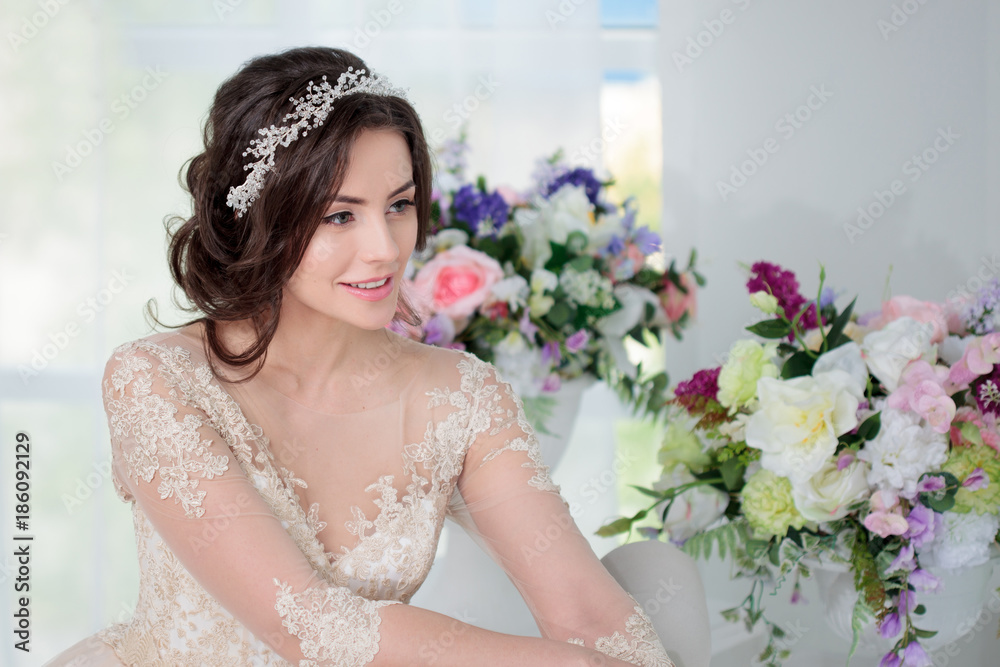 Portrait of beautiful girl in a luxurious wedding dress. Interior ...