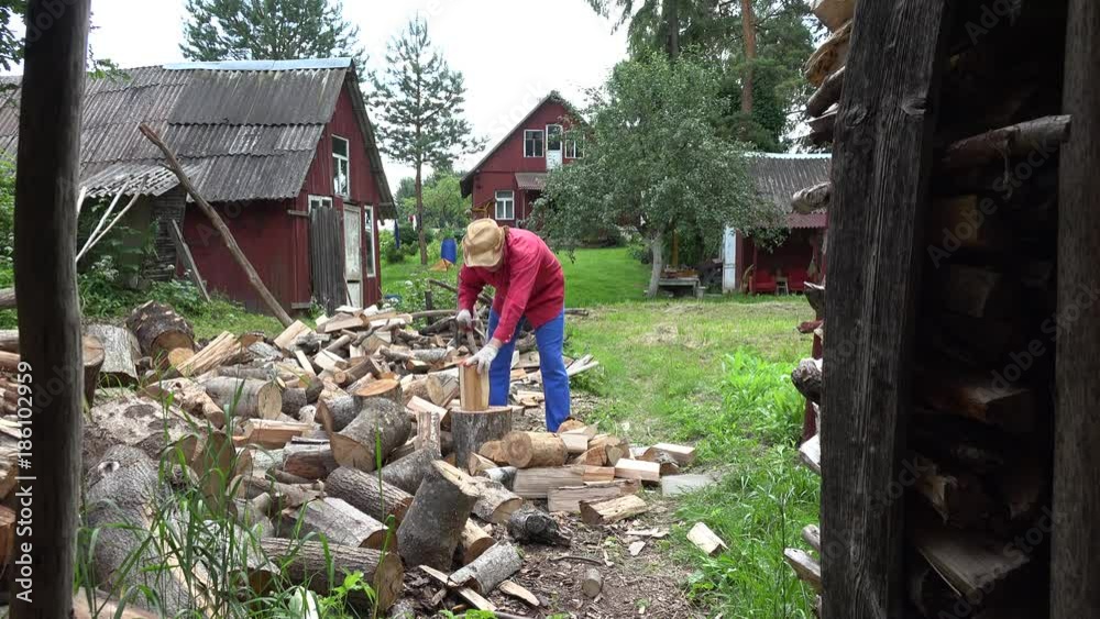 Vídeo do Stock: Strong villager guy preparing natural wood fuel and ...
