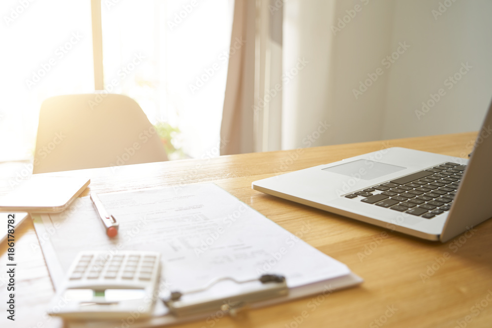 Wide angle perspective view of office workplace with laptop and smart ...