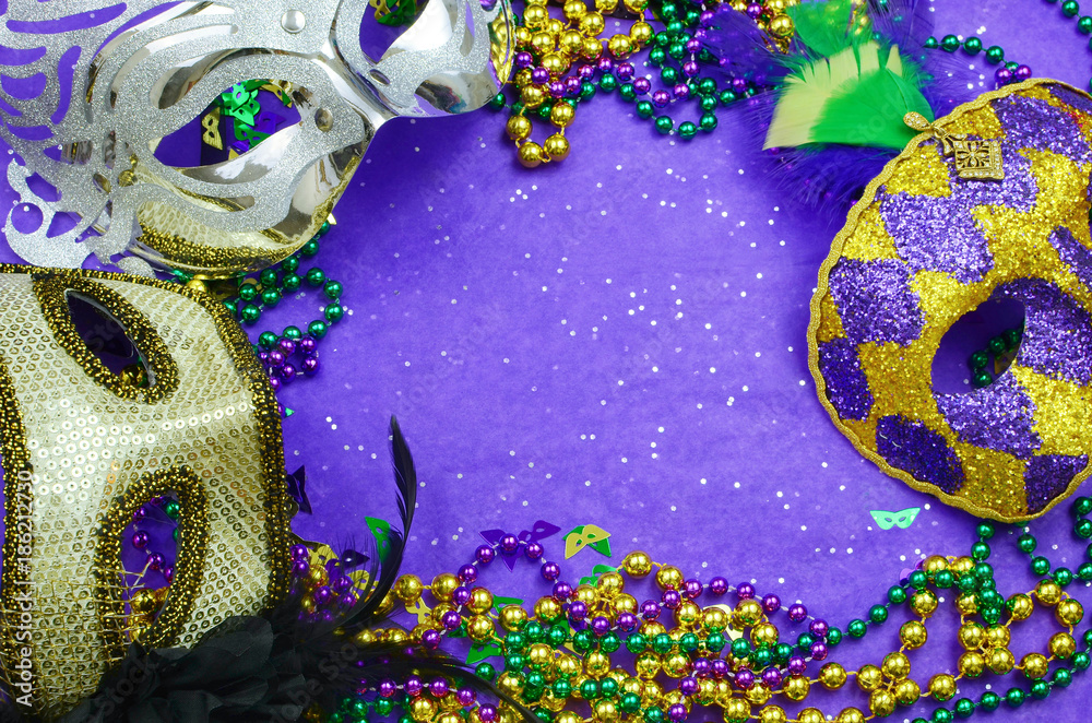 Mardi Gras border or frame of carnival masks, beads, ribbons and ...