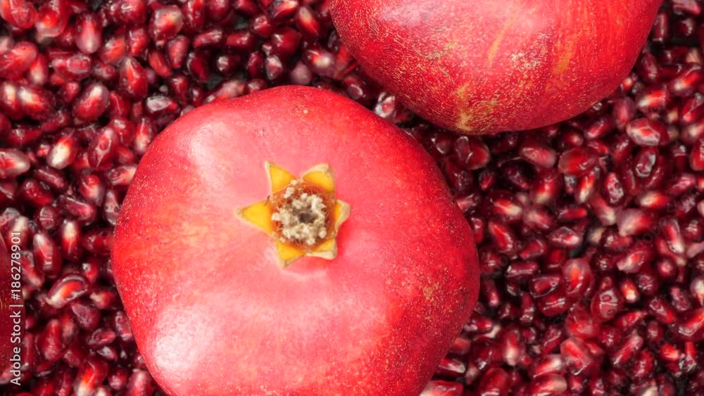 Rotating pomegranate fruit and seeds, top view, 4K. Stock Video | Adobe Stock