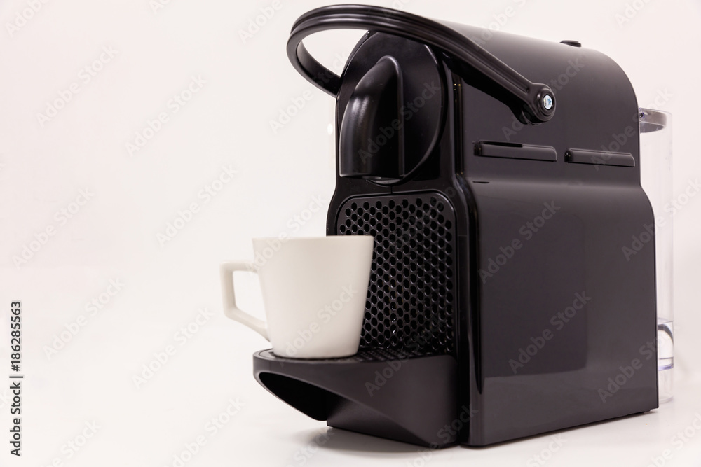 Espresso coffee maker machine in black color with white cup and ...