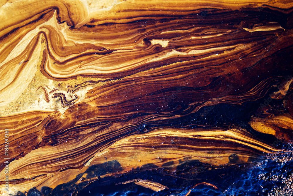 Texture of crude oil spill, pools of crude oil floating on the surface ...