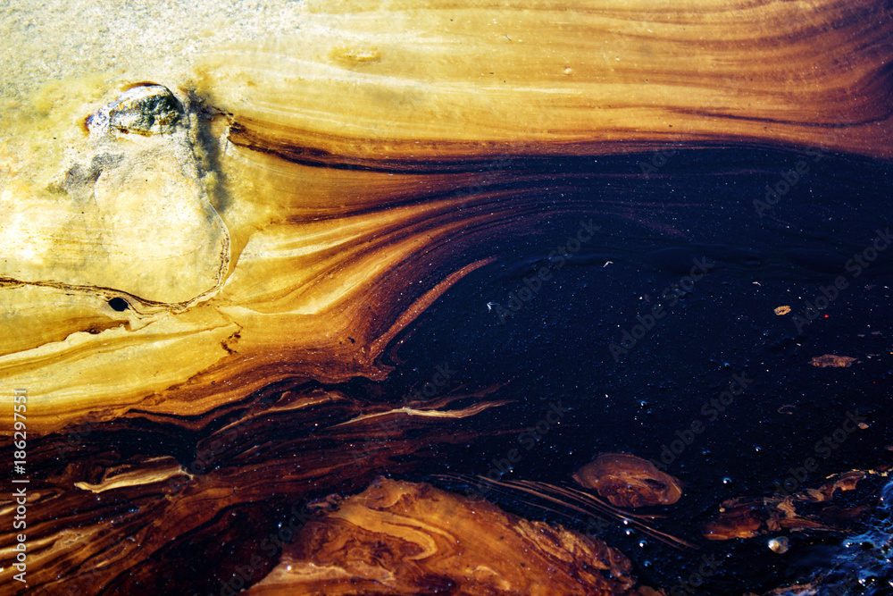 Texture of crude oil spill, pools of crude oil floating on the surface ...