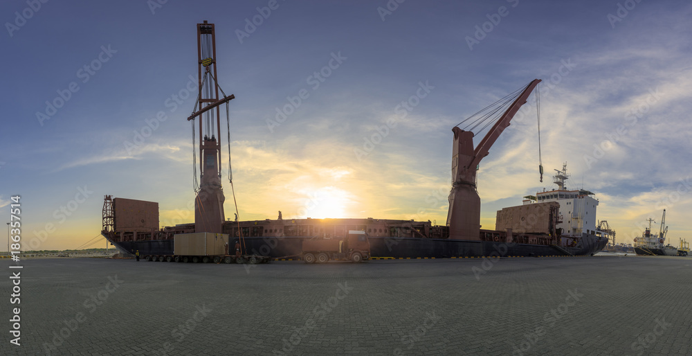 panorama of heavy lift, general cargo vessel alongside the jetty port ...