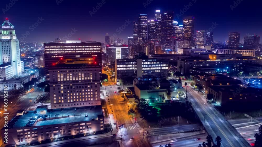Cinematic urban aerial view of downtown streets with city skyline at ...