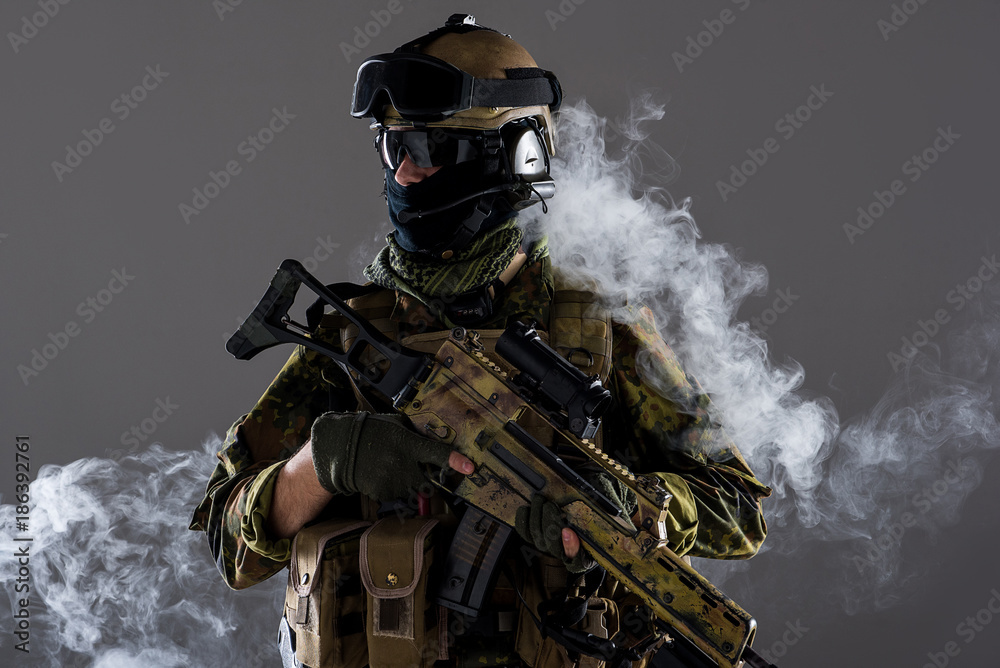 Side view stern soldier wearing military ammunition while keeping ...