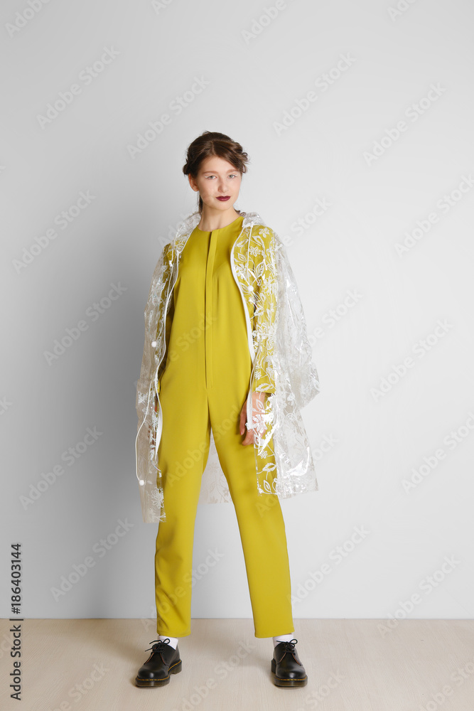 Pretty young girl in yellow overalls and PVC raincoat Stock Photo ...