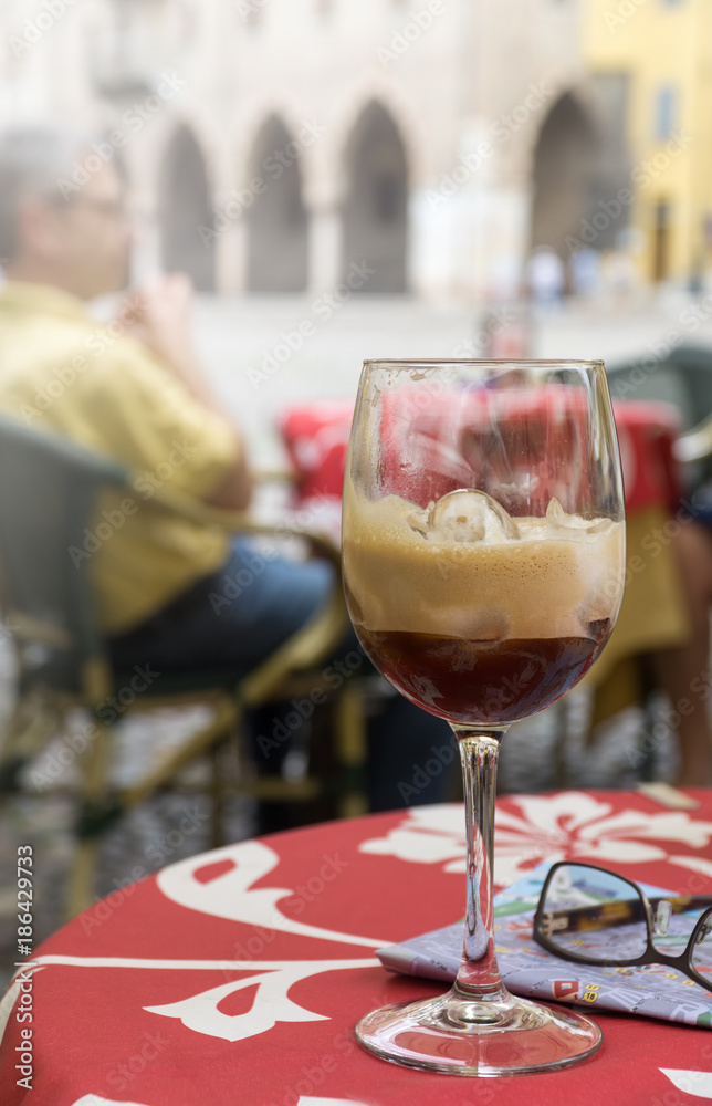 Foto de A glass of shakerato on a red tablecloth in an Italian cafe on ...