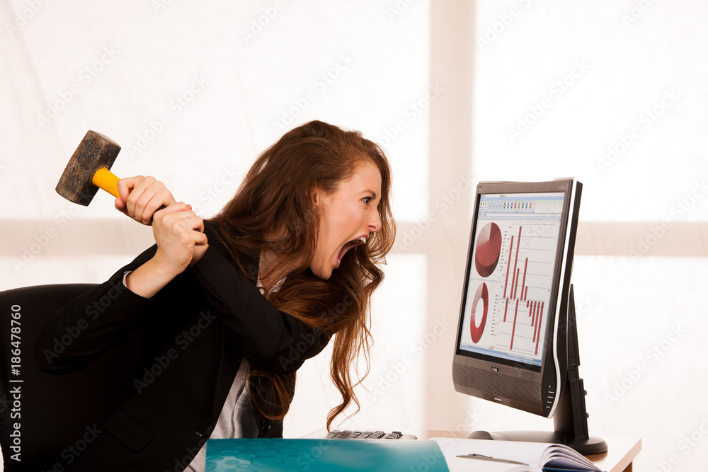 Angry business woman expressing rage at her desk in the office Stock ...