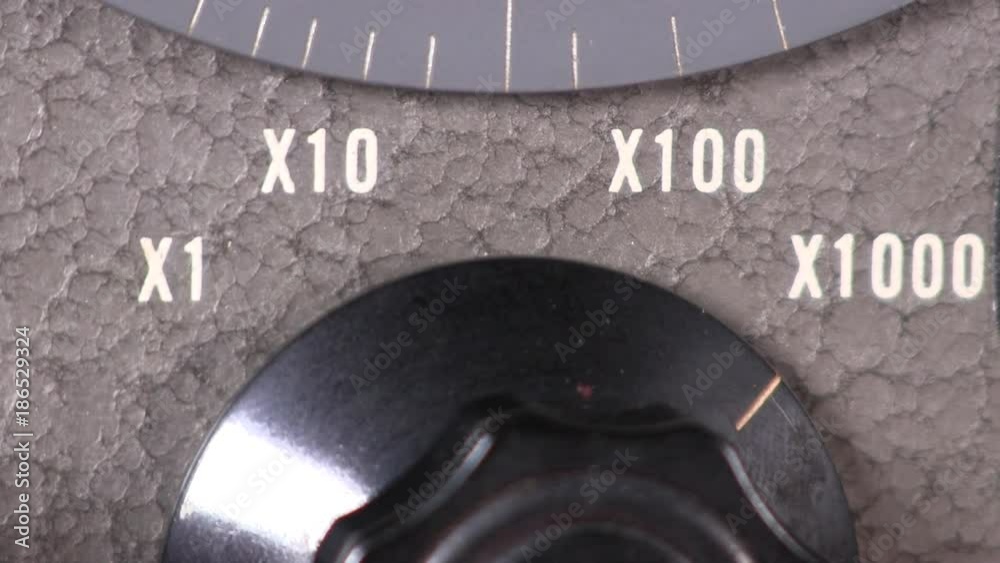 Close-up macro of scale knob adjustment up from X1 X10 X100 X1000 and ...