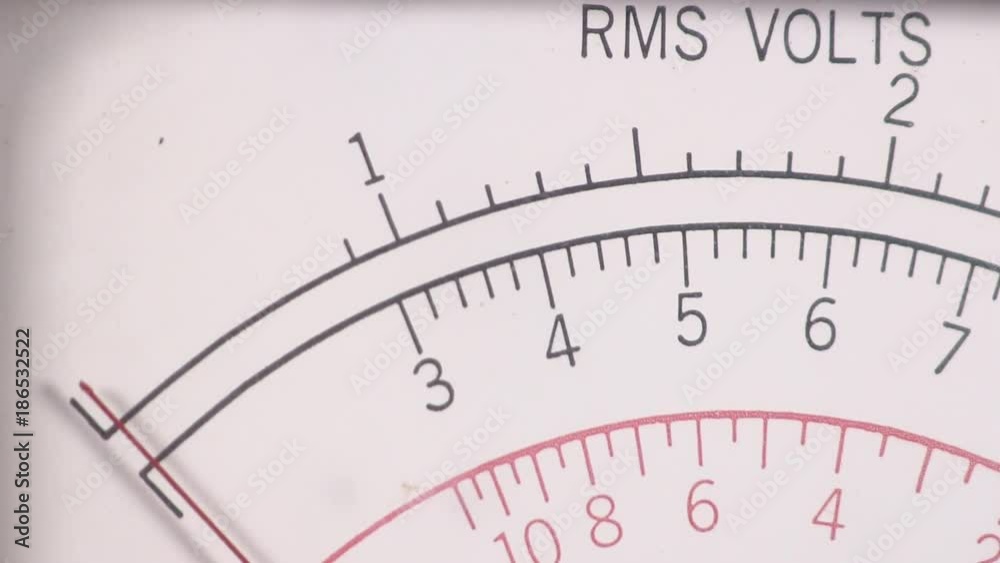 Extreme close-up of RMS volt meter needle movement reading level on ...