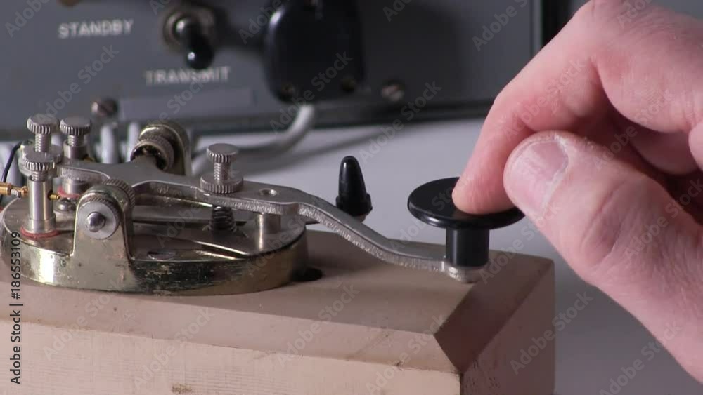 Vidéo Stock Extreme close-up of finger pressing telegraph key sending morse code radio ...
