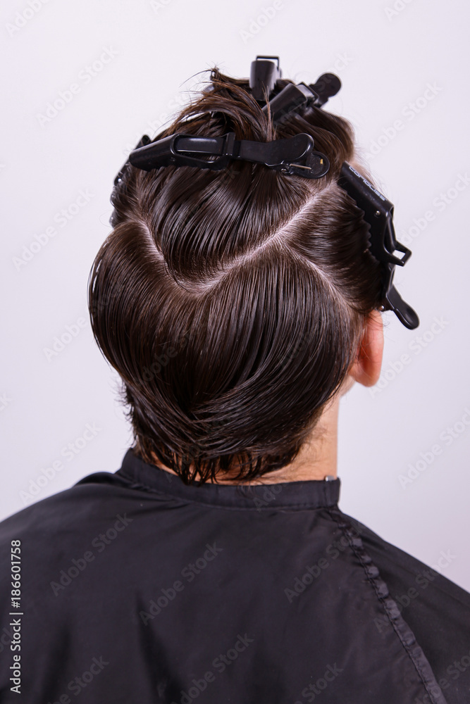 The process of male haircuts. A hairdresser is cutting a guy. Barber ...
