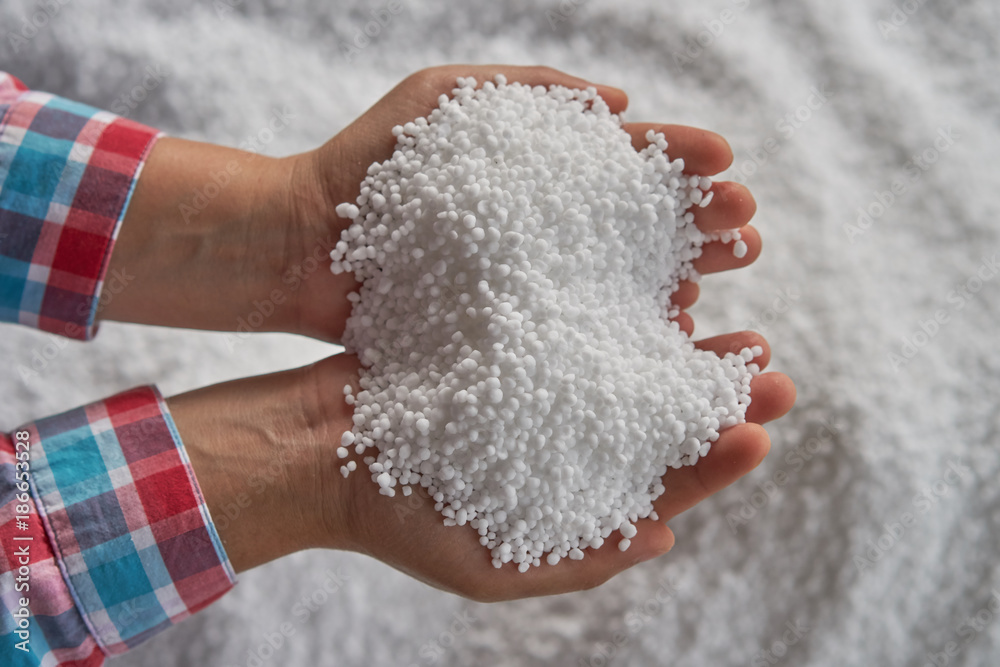 Nitrogen fertilizers or urea fertilizer in farmer hand. blur.white ...