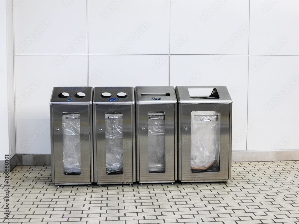 4 different trash containers for each type of waste: canned paper ...