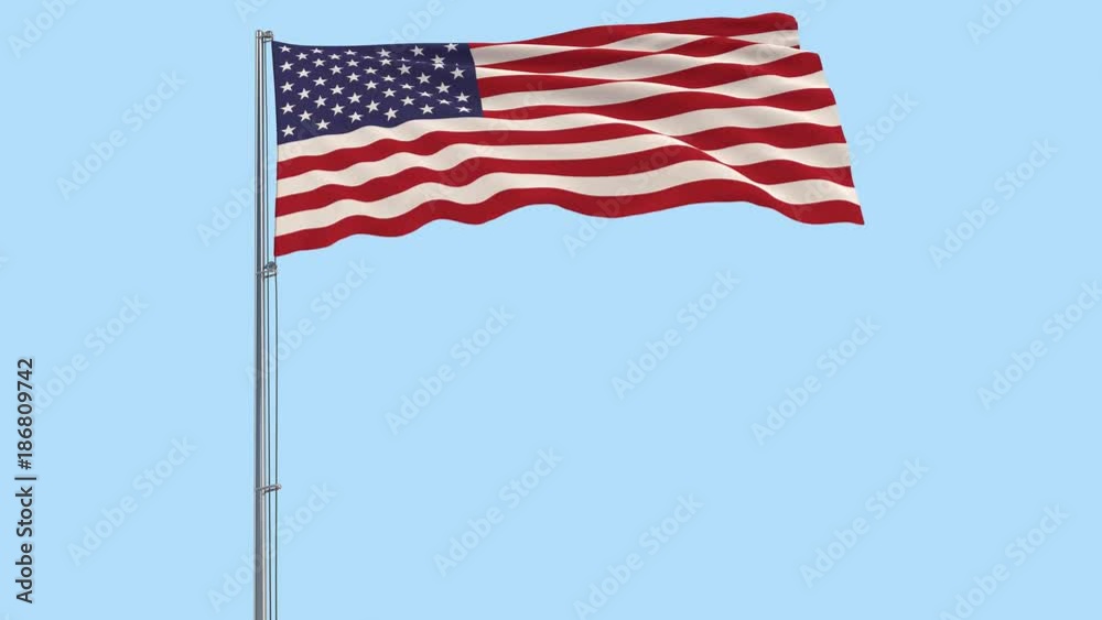 Isolated large cloth of USA on a flagpole fluttering in the wind on a ...