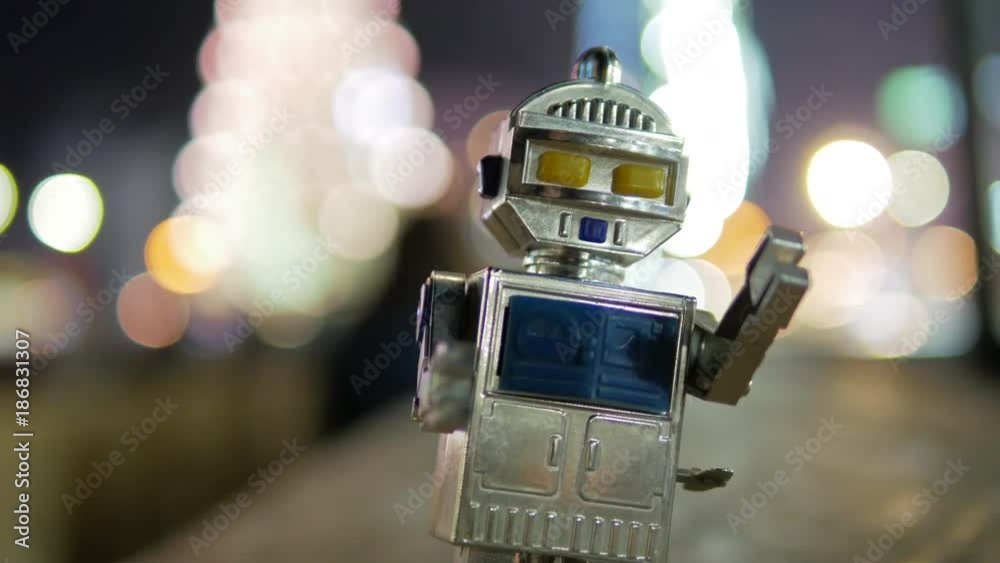 Soviet robot the toy walks around night city center with beautiful ...