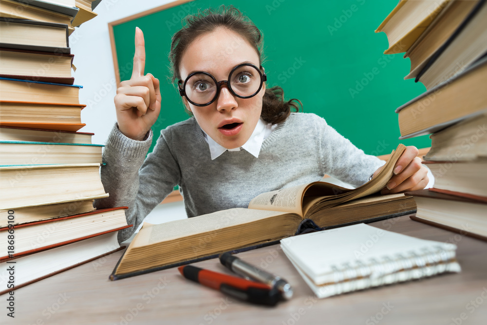 Did you know that?! Curious student reads a books. Photo of astonished ...