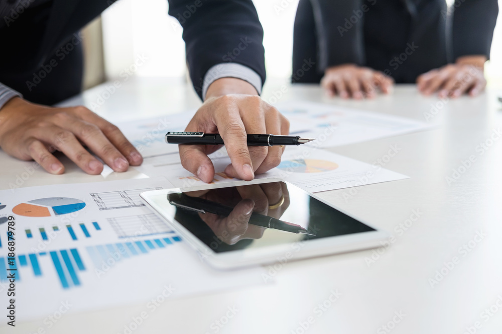 Business team two colleagues discussing working with many document ...