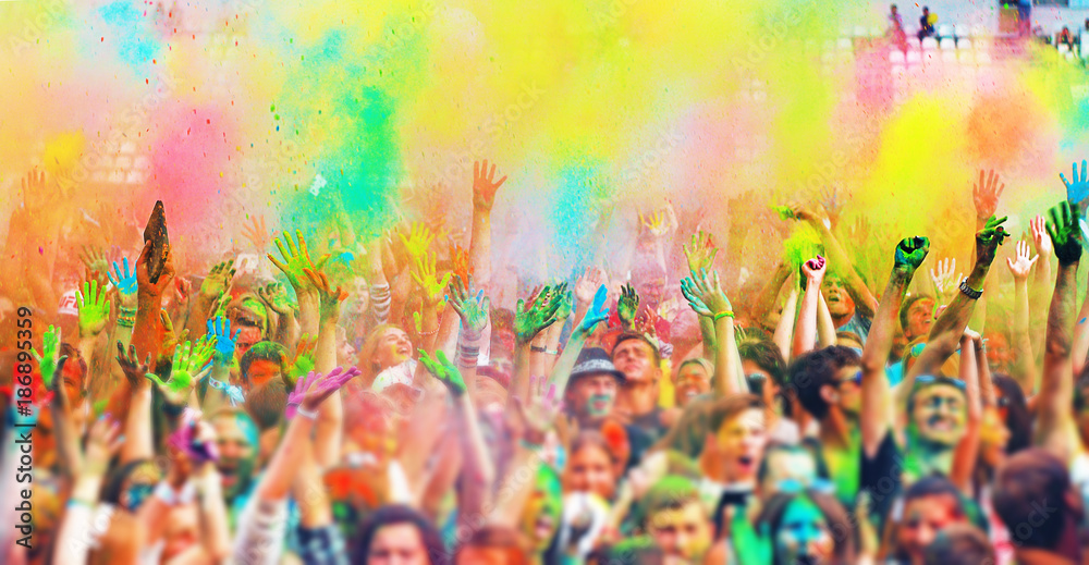 Indian holiday holi, a group of happy people throws multicolored powder ...