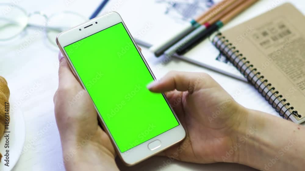 smartphone in the hands of a green screen in a cafe swipe up, smart ...