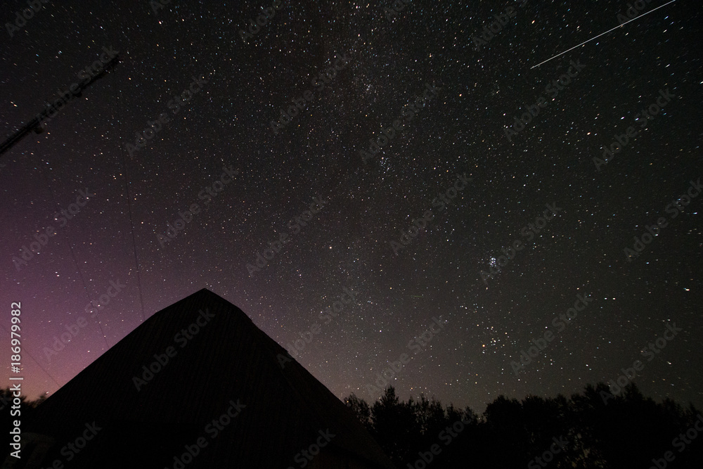 Abstract shot of starry sky. Stars are falling on clear blue night-sky ...