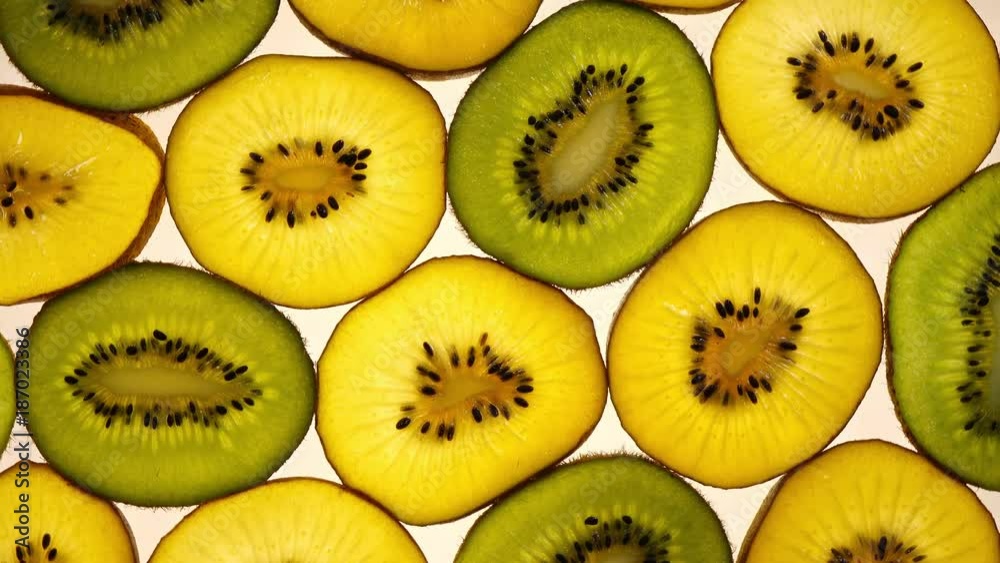 Excellent top view of sliced green and golden kiwi fruit in flat lay ...