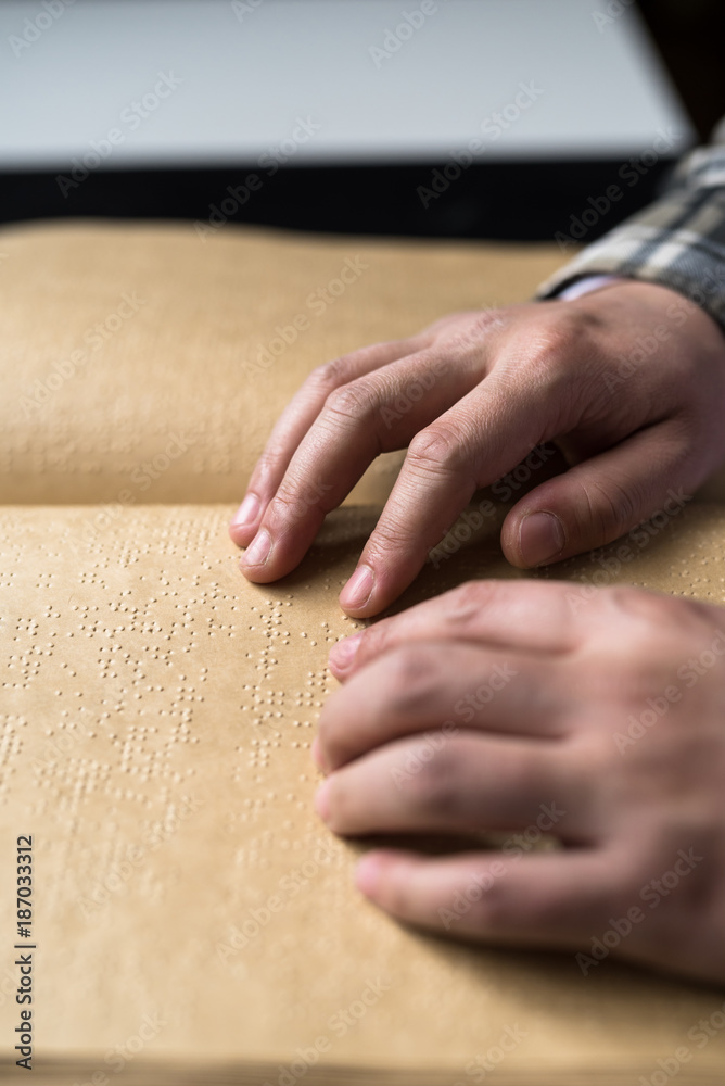 Blind man reading braille Stock Photo | Adobe Stock