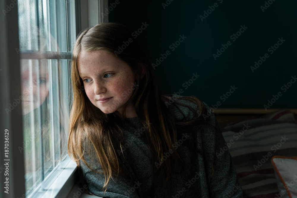'Tween girl gazing out a window Stock Photo | Adobe Stock