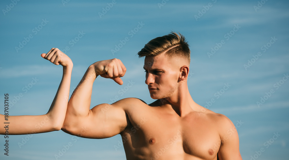 Bodybuilder with strong hand biceps, triceps contest with female hand ...