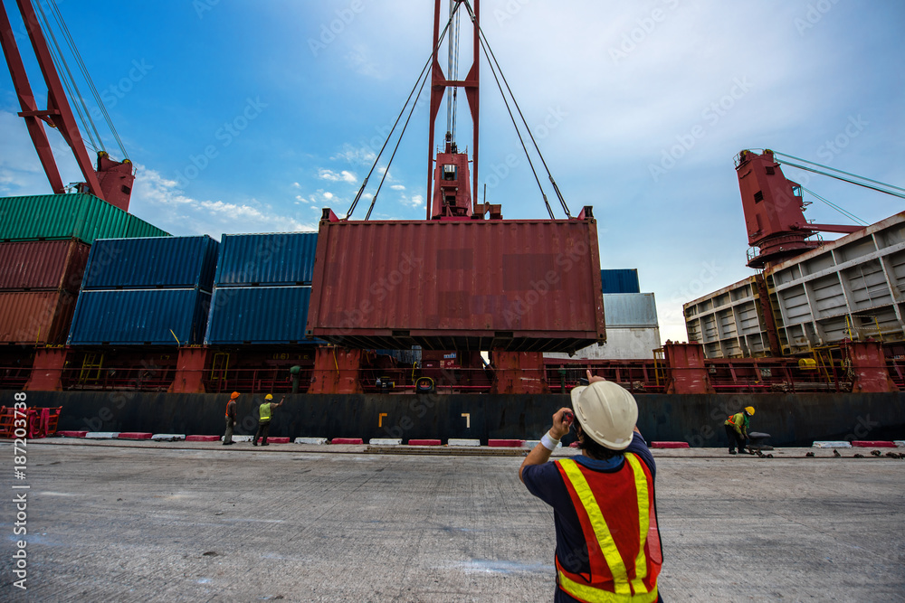 container unit loading onto the bay of ship from terminal yard by the ...