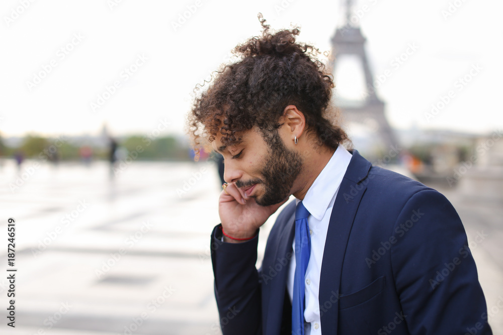 Jocund guy raving near Eiffel Tower and calling friend b Stock Photo ...