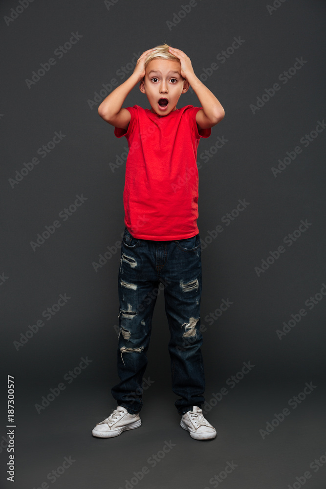 Shocked little boy child standing isolated Stock Photo | Adobe Stock