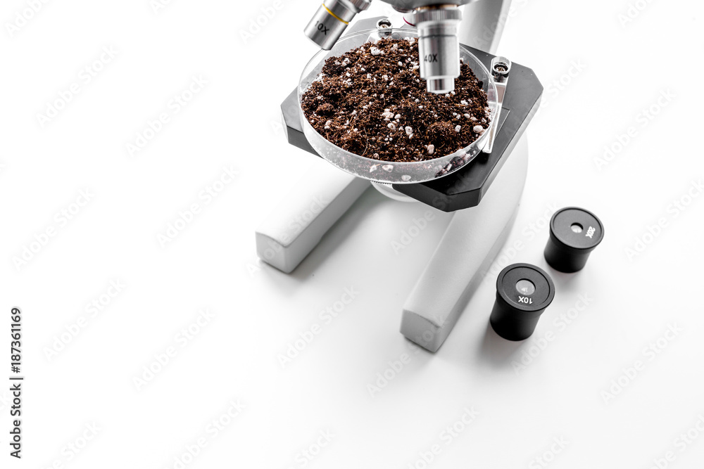 Analysis process. Soil under microscope on white background Stock Photo ...