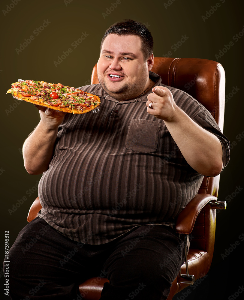 Fat man eating fast food and offers great pizza to customers . Male ...