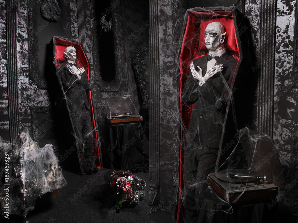 the halloween coffin with the dead vampire puppet of a man standing ...