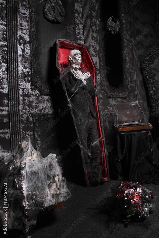 the halloween coffin with the dead vampire puppet of a man standing ...